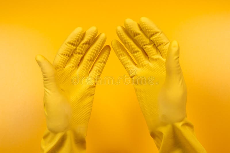 Hands in Yellow Gloves on a Yellow Background Stock Image - Image of ...