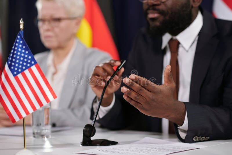 Hands of Young Confident Representative of USA Speaking in Microphone ...