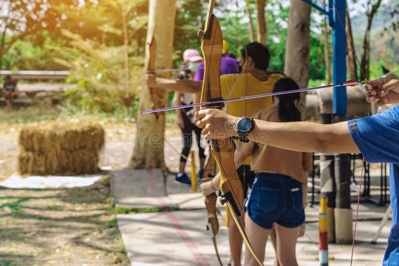 Hands of Young Man Aims Archery Bow and Arrow To Colorful Target in ...