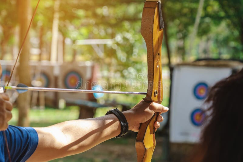 Hands of Young Man Aims Archery Bow and Arrow To Colorful Target in ...