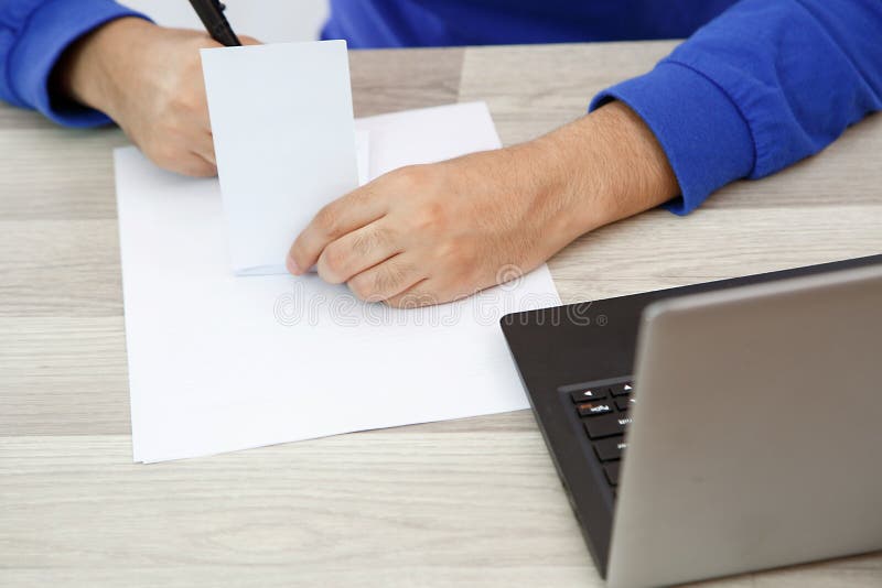 Hands of a Young Man Writing on a Piece of Paper Stock Photo - Image of ...