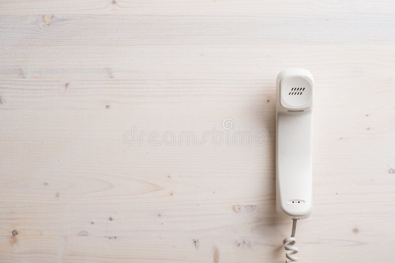 Handset of a White Landline Phone Placed on Plain Wooden Board Stock ...