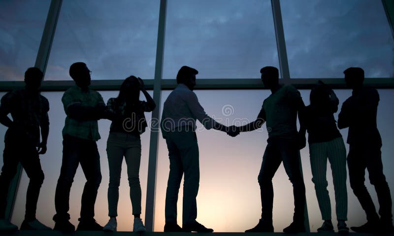 Handshake of Business Partners on the Background of the Office Window ...