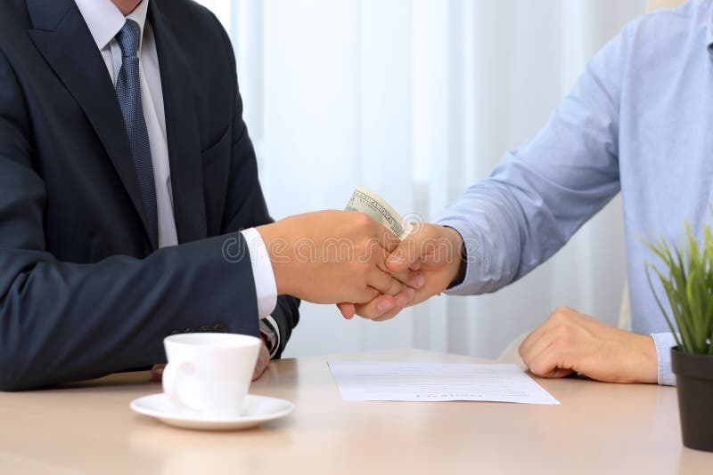 Handshake of Businessmen with Money. Blue Background Behind Stock Image ...