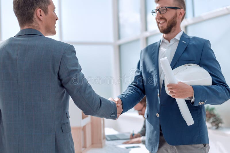 Handshake Contractor and Architect on the Background of the Office ...