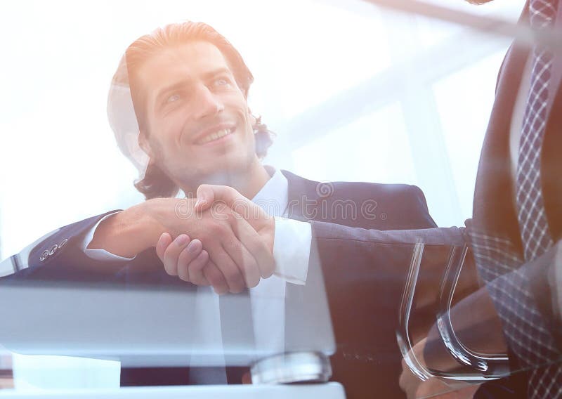 Handshake Creative Partner,sitting Behind a Desk. Stock Photo - Image ...