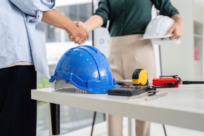 Handshake in Engineering. Young Engineers Sealing a Deal in a ...