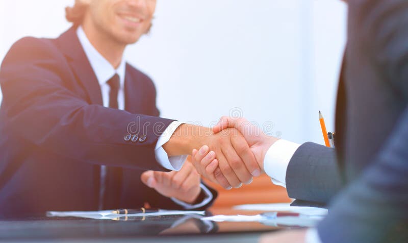 Handshake Manager and the Client Sitting in the Office Stock Photo ...
