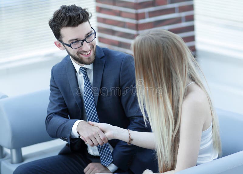 Handshake of Manager and Client Sitting in the Office Lobby. Stock ...