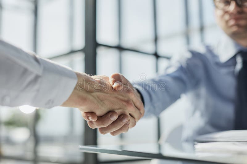 Handshake of Manager and Client Sitting at Table in Modern Office Stock ...