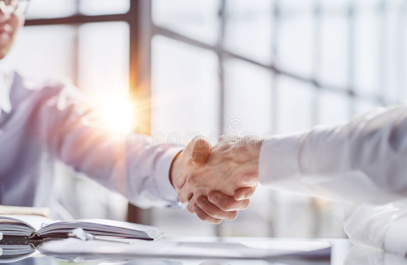 Handshake of Manager and Client Sitting at Table in Modern Office Stock ...