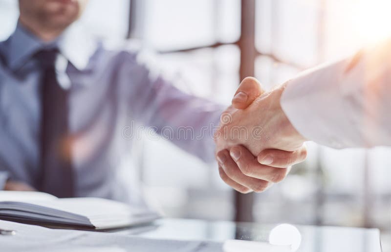 Handshake of Manager and Client Sitting at Table in Modern Office Stock ...