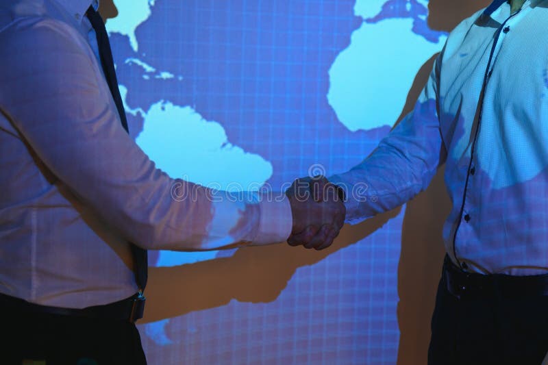 Handshake with Map of the World in Background Stock Image - Image of ...