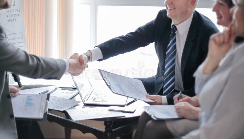 Handshake of Senior Business Partners on the Desk Stock Photo - Image ...