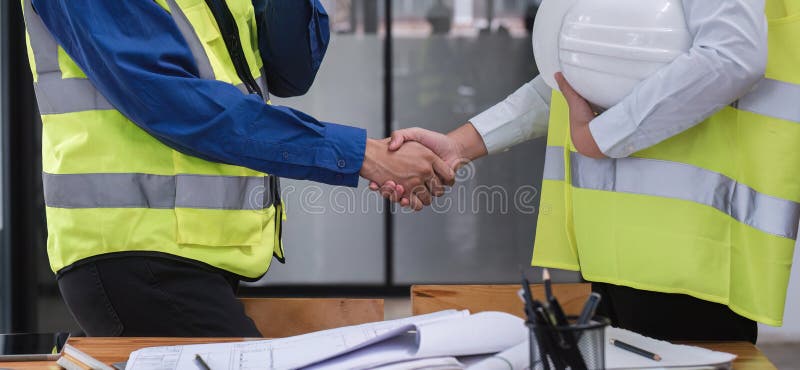 A Handshake between a Team of Engineers Working Together To Plan a ...
