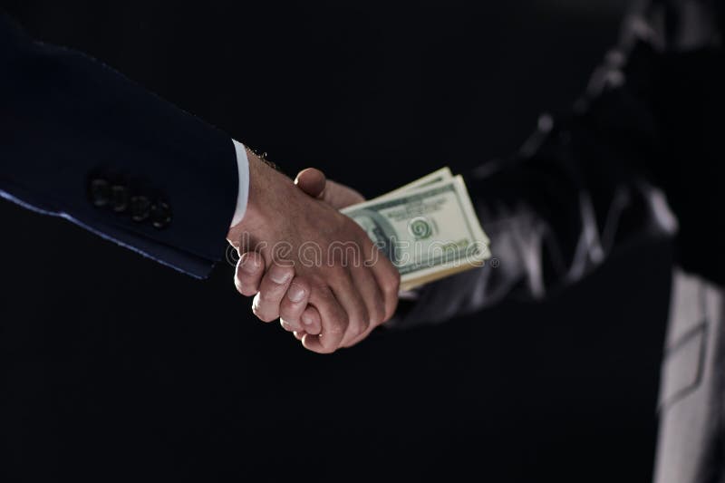 Handshake with the Transfer of Money on a Black Background Stock Image ...