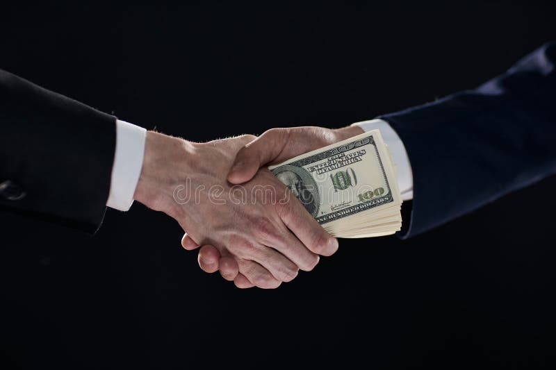 Handshake with the Transfer of Money on a Black Background Stock Image ...