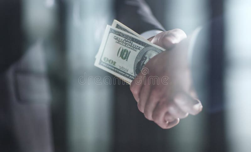 Handshake with the Transfer of Money on a Black Background Stock Image ...