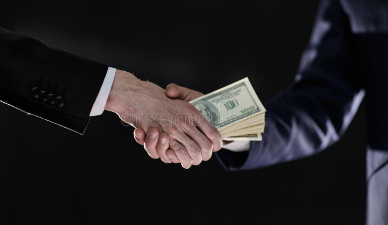 Handshake with the Transfer of Money on a Black Background Stock Image ...