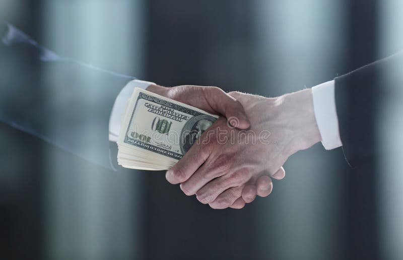 Handshake with the Transfer of Money on a Black Background Stock Image ...