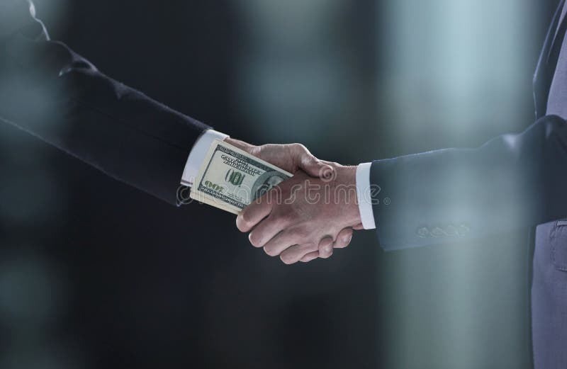 Handshake with the Transfer of Money on a Black Background Stock Image ...