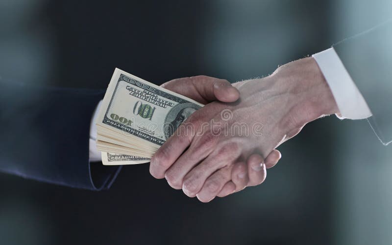 Handshake with the Transfer of Money on a Black Background Stock Image ...