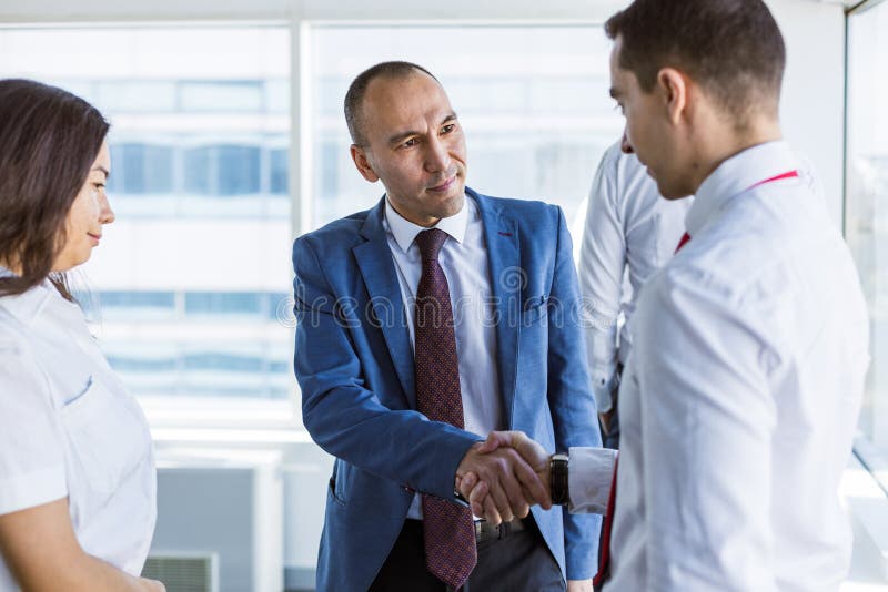 Handshake of Two Business Partners Communicating in the Office at a ...