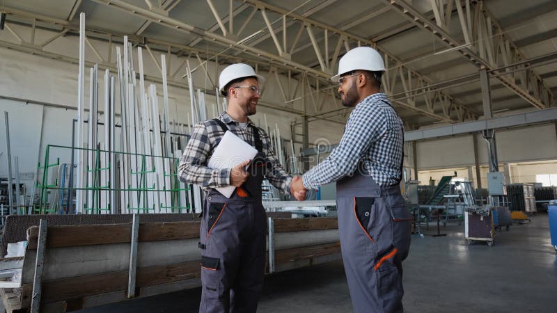 Handshake Two Diverse Engineers on the Background of a Windows Factory ...