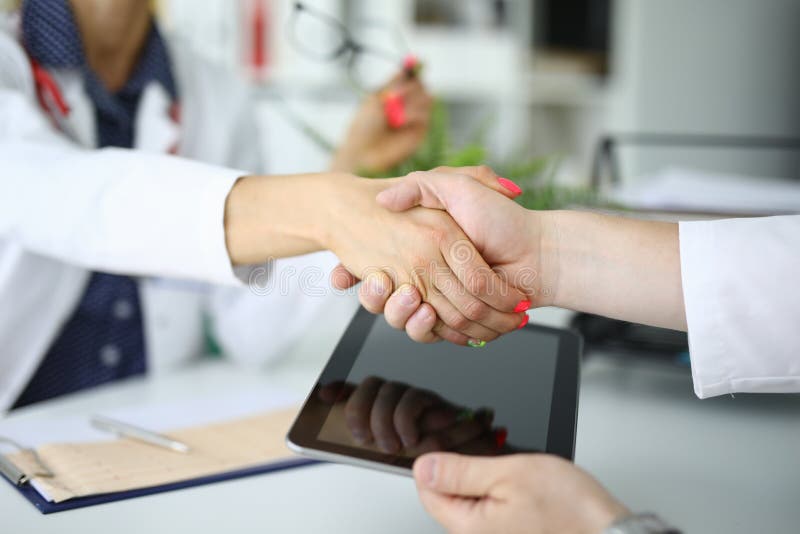 Handshake of Two Doctors One is Holding Tablet. Stock Image - Image of ...