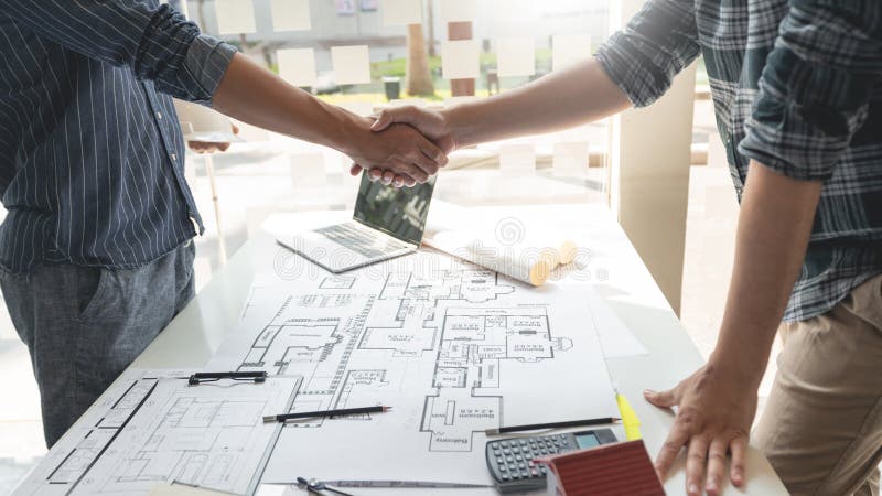 Handshaking between an Architect and a Contractor of Agreement after ...