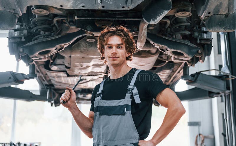 Handsome Adult Man in Grey Colored Uniform Standing Below Automobile ...