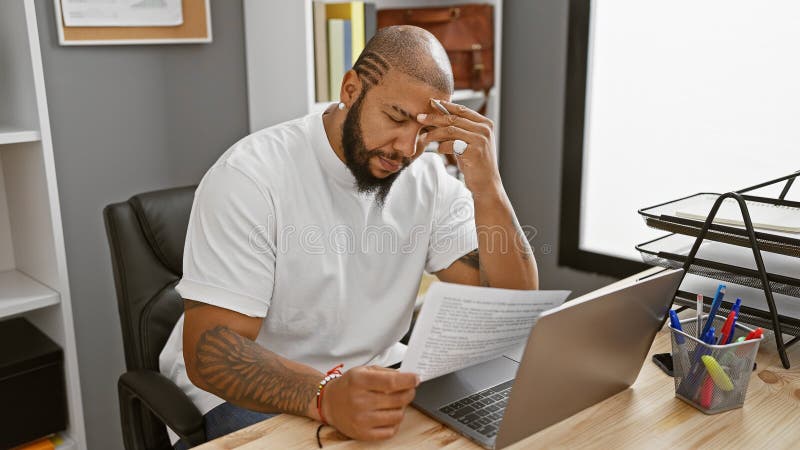 Handsome African American Man with Beard in Office Reading Document ...