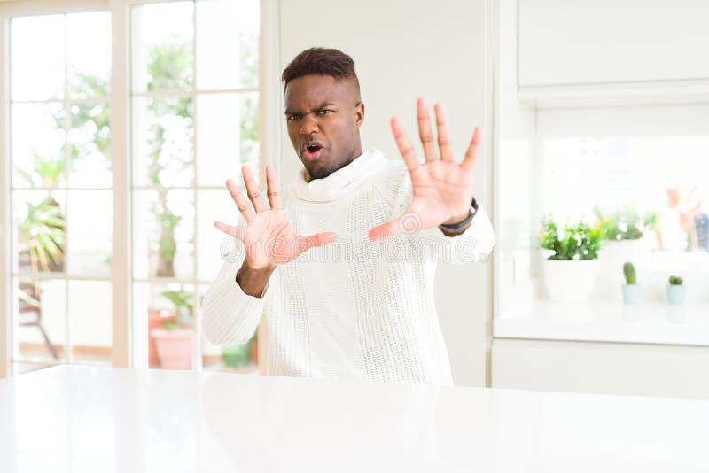 Handsome African American Man on White Table Afraid and Terrified with ...