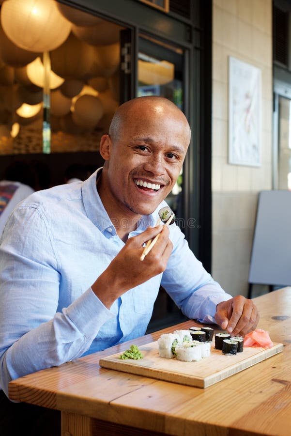 Handsome African Man Eating Sushi Stock Image - Image of casual ...