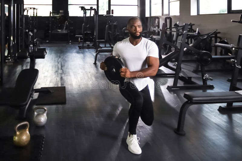 Handsome African Man is Working Out with Dumbbells at Gym. Stock Photo ...