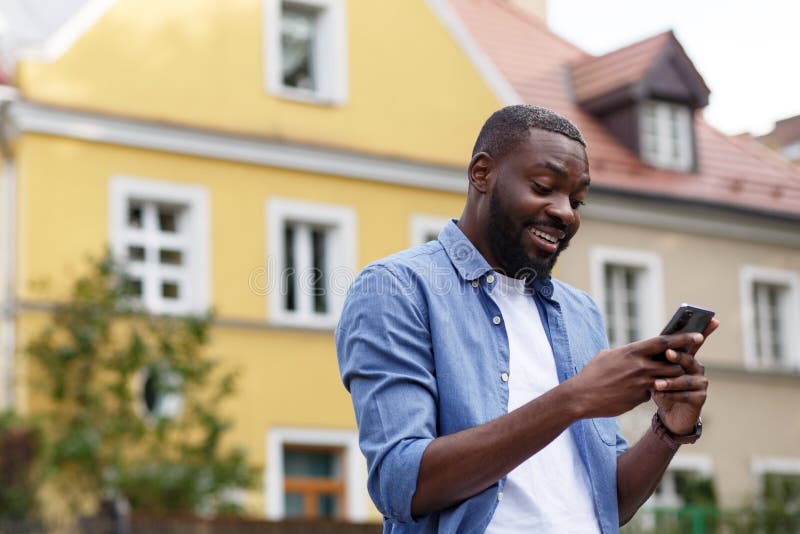 Handsome Afro-American Man Using Smartphone and Smiling. Happy Man ...