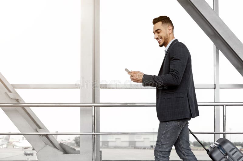 Handsome Arab Guy Using Smartphone Walking Suitcase Airport Terminal ...