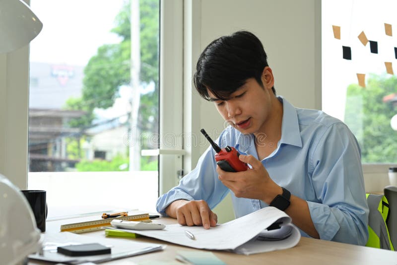 Handsome Architects Man Working on Construction Plans and Communicating ...