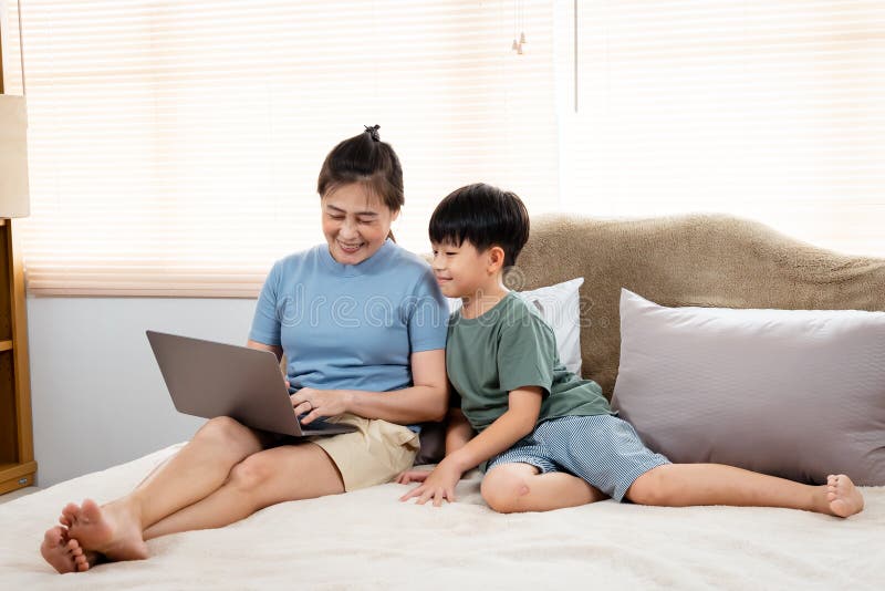 Handsome Asian Boy, Looking at the Laptop Computer in Front of Him, he ...