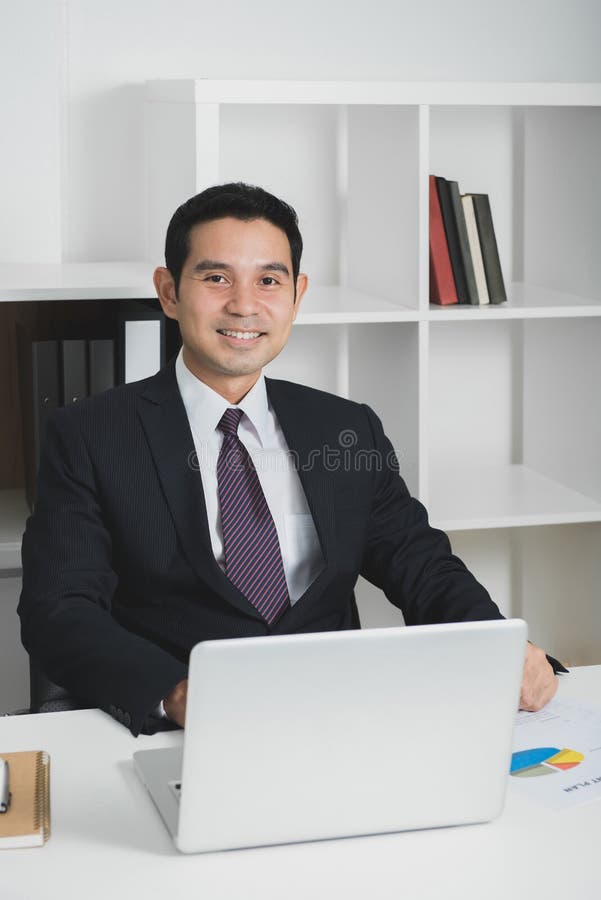 Handsome Asian Businessman at Work with Laptop Computer on the T Stock ...