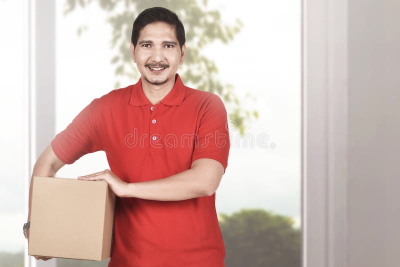Handsome Asian Courier Man Holding the Package Stock Image - Image of ...