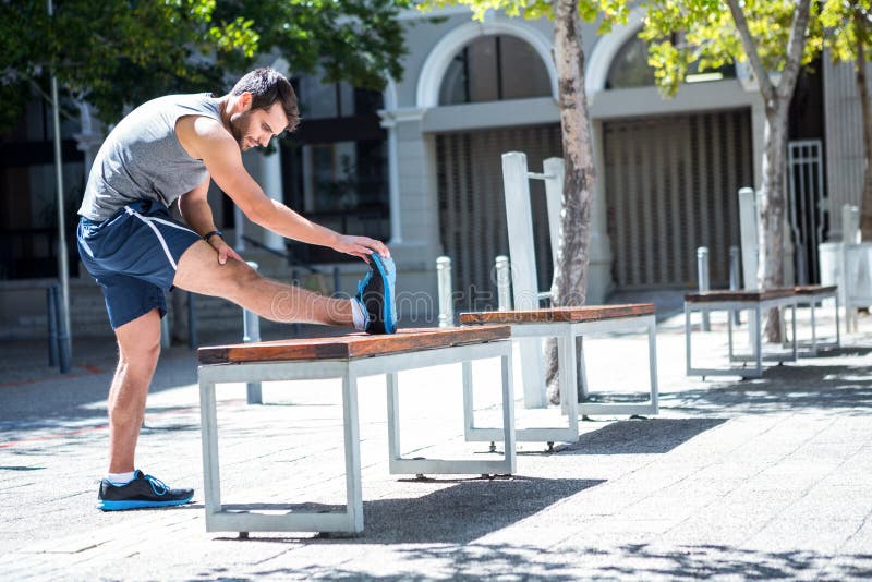 Handsome Athlete Doing Leg Stretching on a Bench Stock Photo - Image of ...
