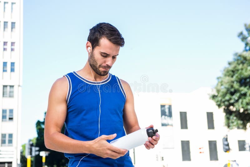 Handsome Athlete Looking at Bottle Stock Photo - Image of healthy ...