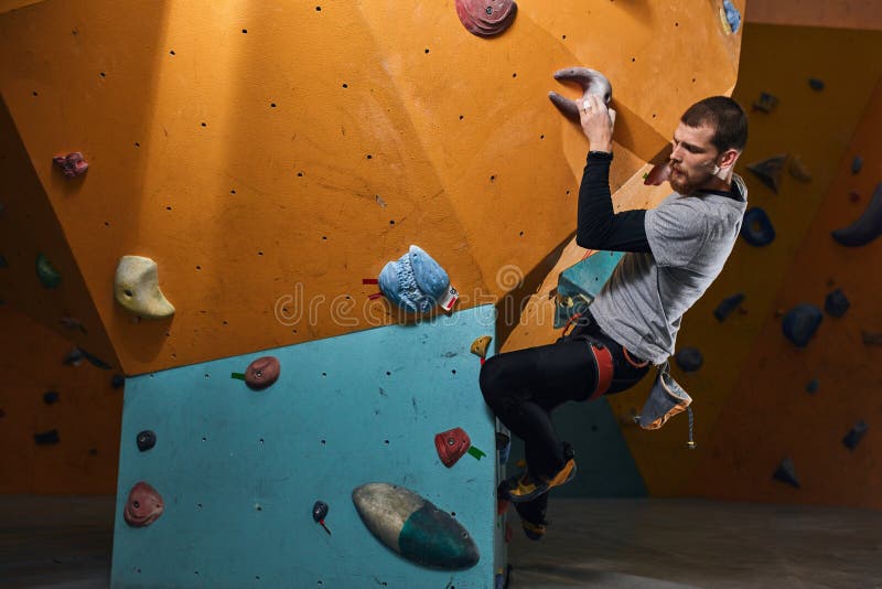 Handsome Athletic Boulderer Training Hard at Indoor Climbing Settings ...