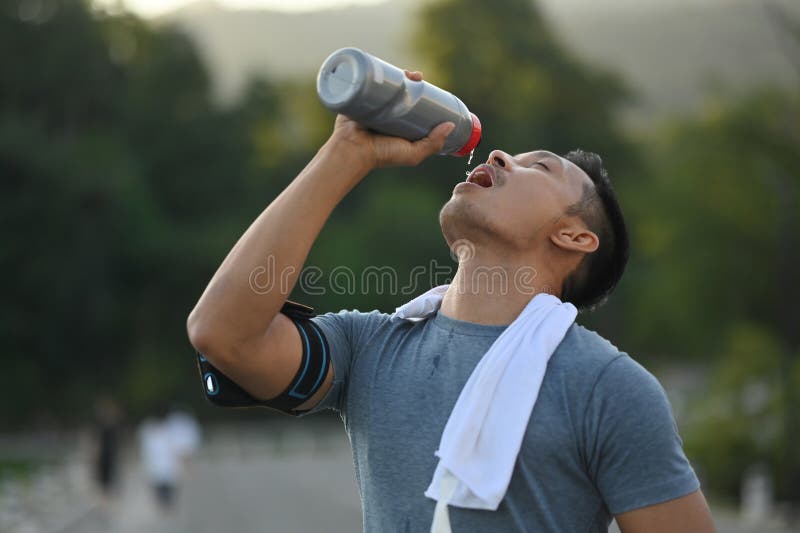 Handsome Athletic Male Drinking Water from Bottle after Running Resting ...