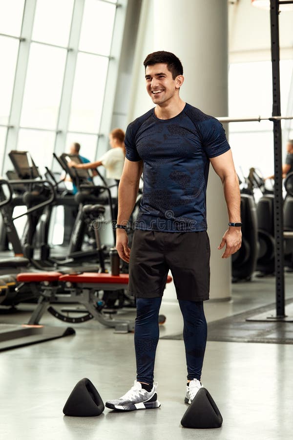 Handsome Athletic Men Exercising with Kettlebell in the Gym Stock Photo ...