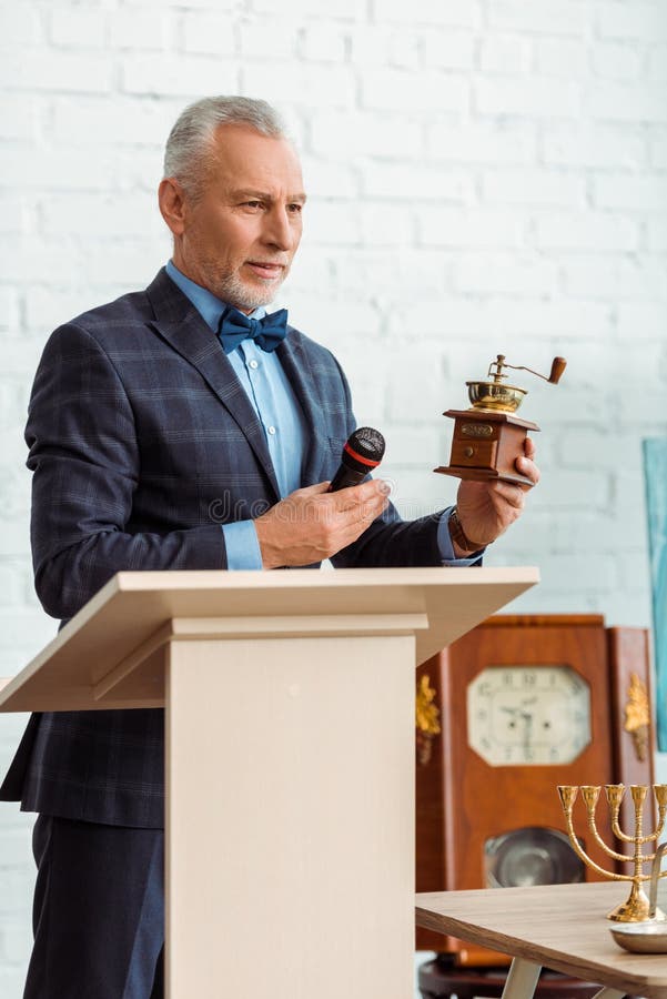 Auctioneer Talking with Microphone and Holding Stock Image - Image of ...