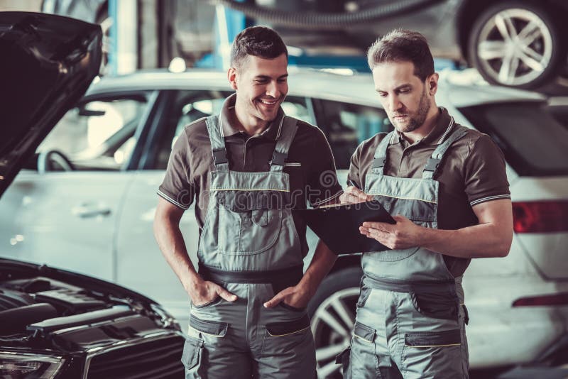 Handsome Auto Service Workers Stock Image - Image of assistant, center ...