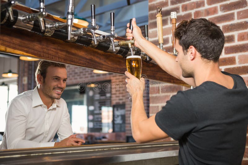 Handsome Bar Tender Pouring a Pint for a Customer Stock Image - Image ...