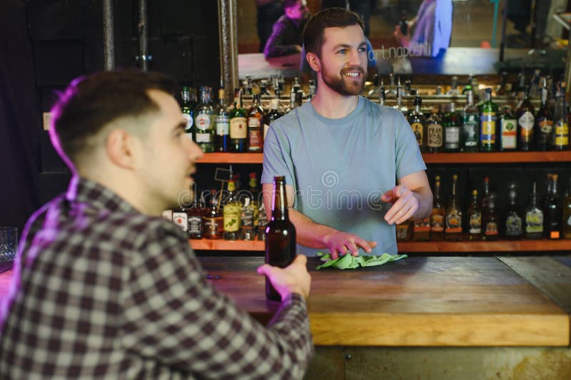 Handsome Bar Tender Standing Behind His Counter in a Pub Stock Photo ...